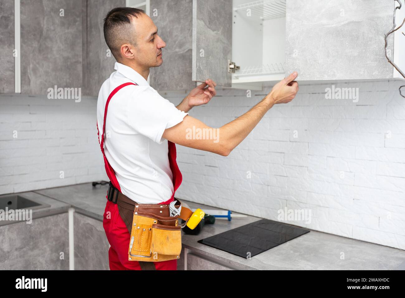 Montage of a man wallpapering Stock Photo - Alamy