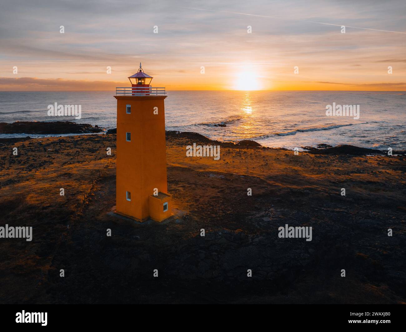 Aerial Drone photo of orange Lighthouse on the seashore in the Iceland ...