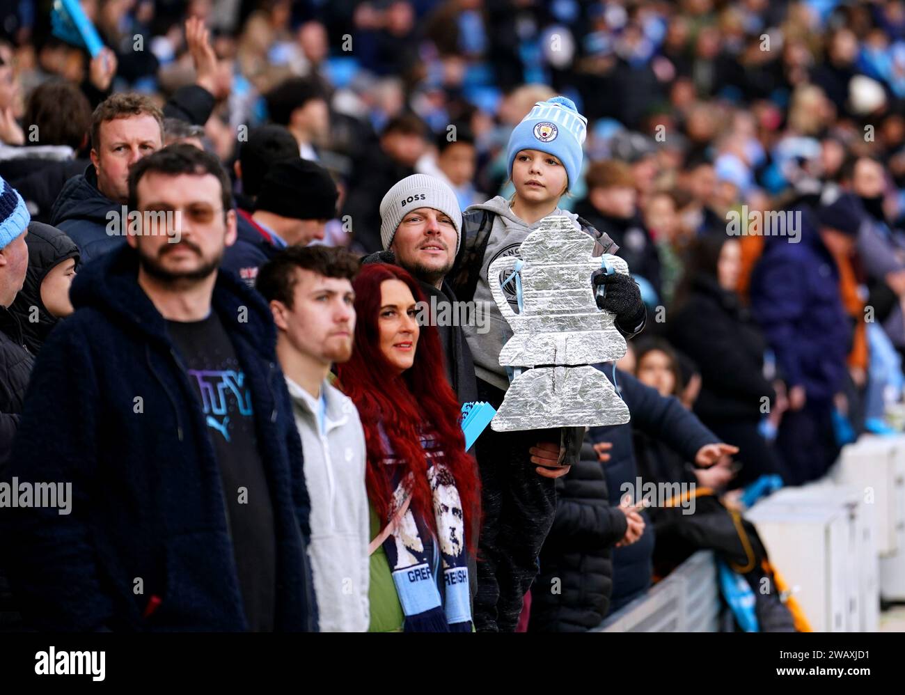 A Manchester City fan holds up a replica of the FA Cup trophy ahead of ...