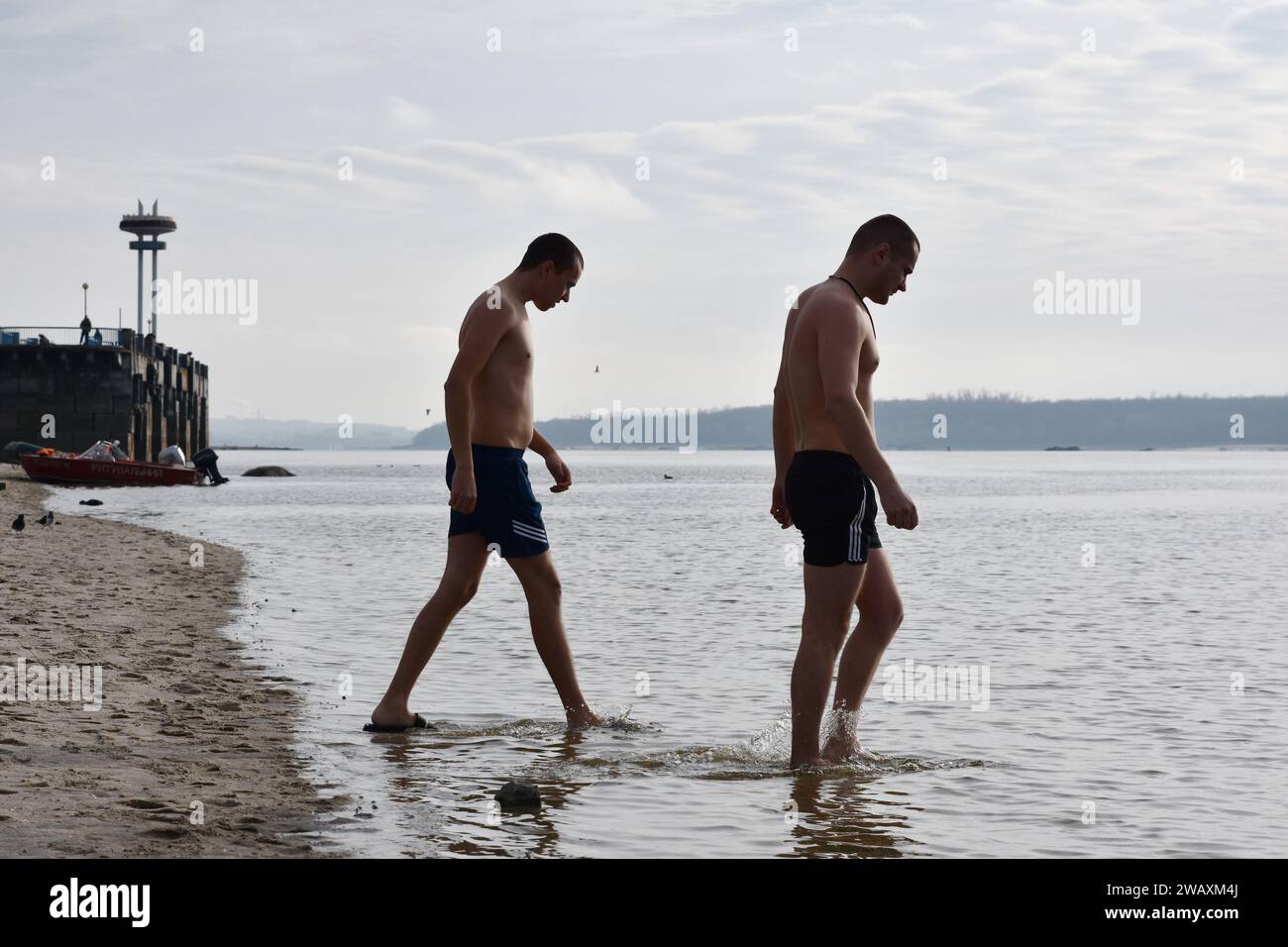 Two men seen heading to dip themselves in cold water of the Dnipro ...