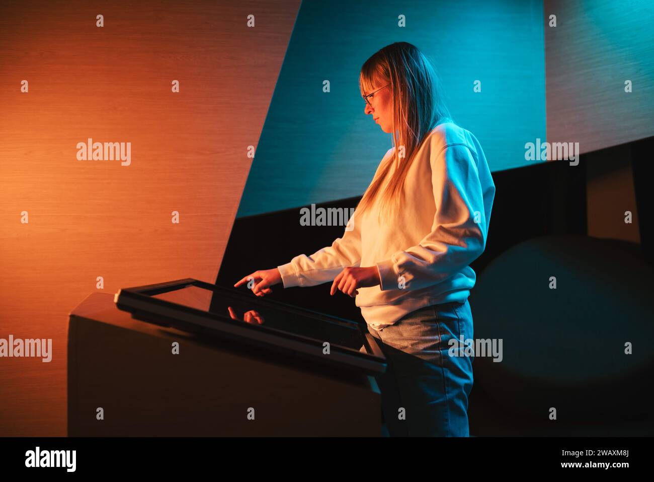 Adolescent girl using touch screen display, skillfully searching ...