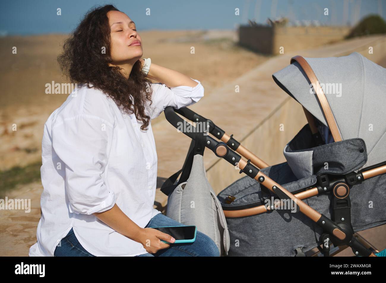 Woman pushing pram phone hi-res stock photography and images - Alamy