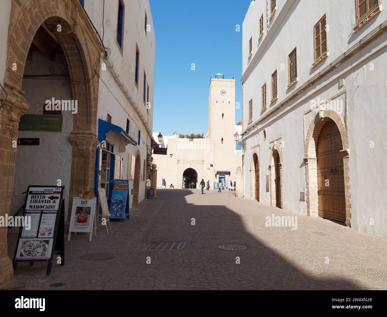 Street in the historic medina with clock tower ahead in the city of ...