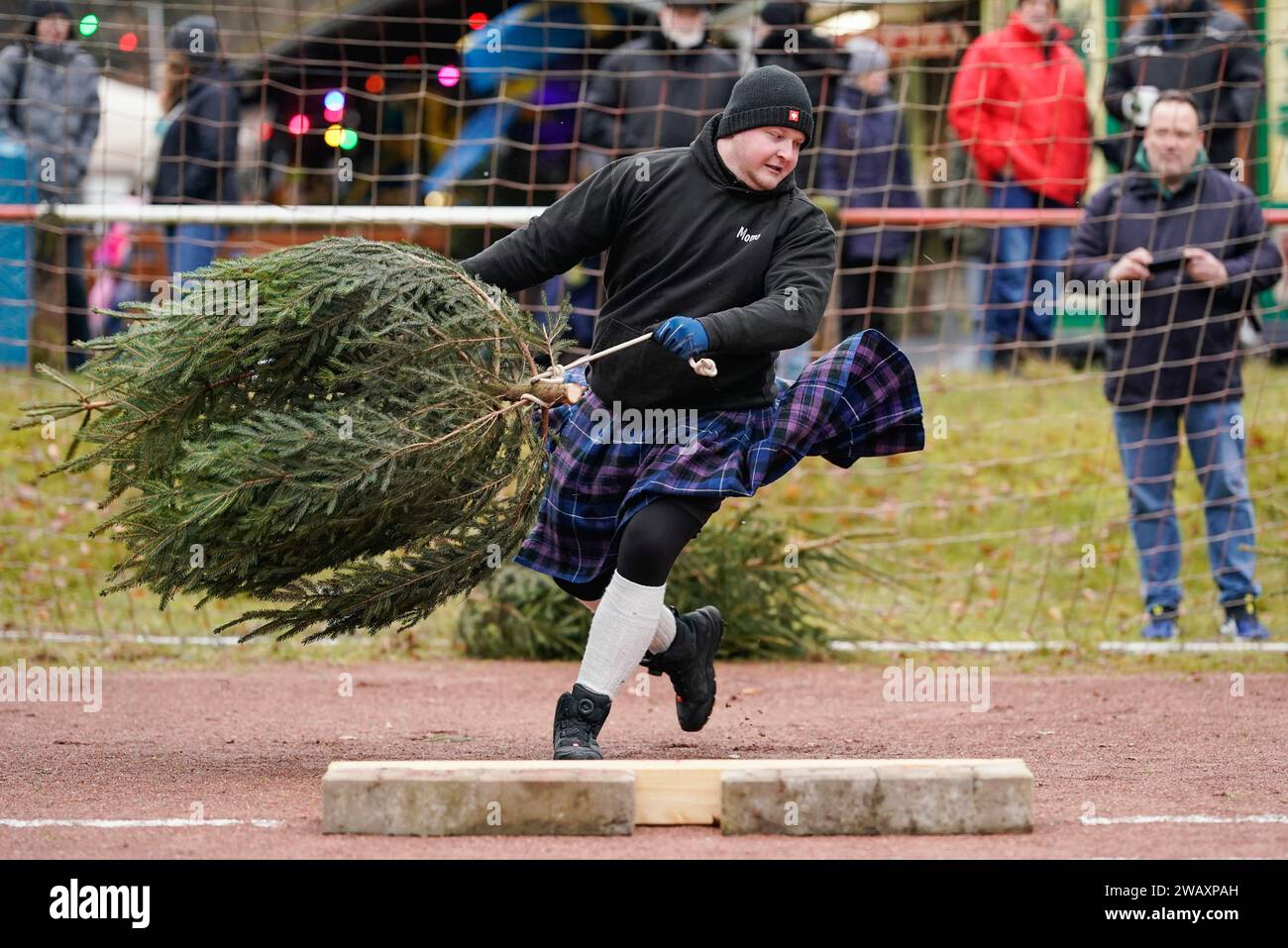 Weidenthal, Germany. 07th Jan, 2024. A participant hurls a spruce at ...