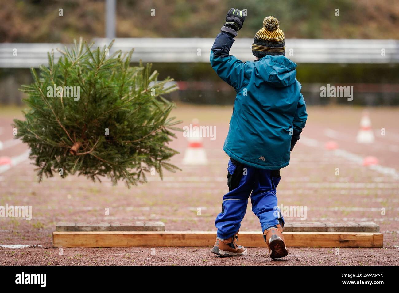 Weidenthal, Germany. 07th Jan, 2024. A child throws a spruce at the ...