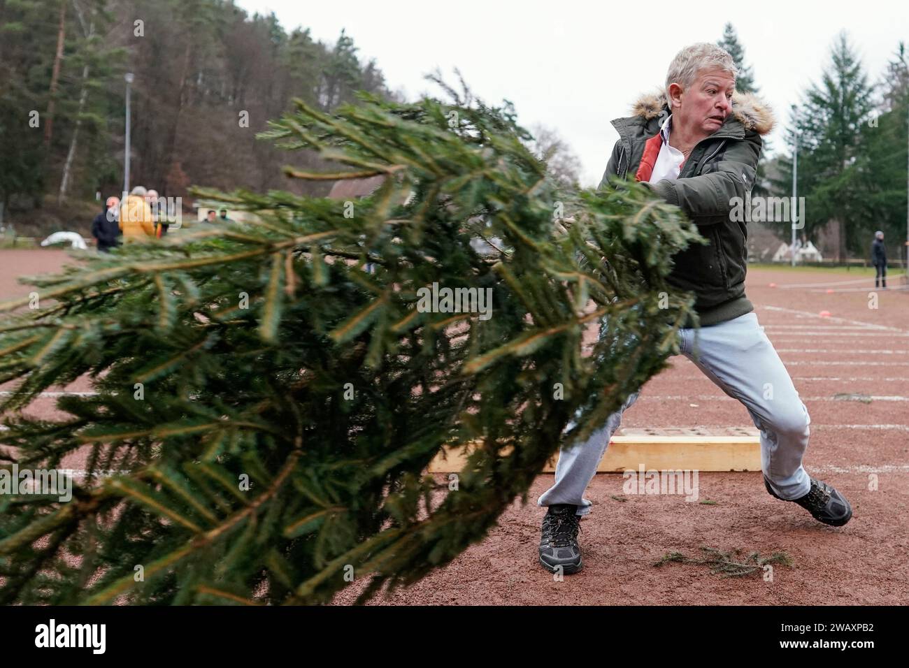 Weidenthal, Germany. 07th Jan, 2024. A participant hurls a spruce at ...