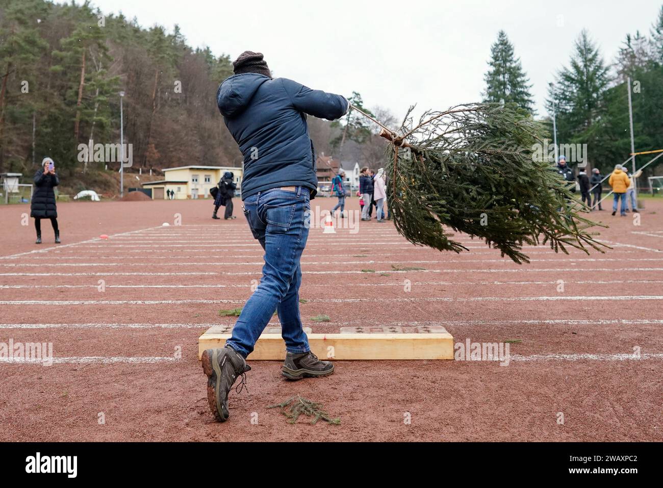 Weidenthal, Germany. 07th Jan, 2024. A participant hurls a spruce at ...