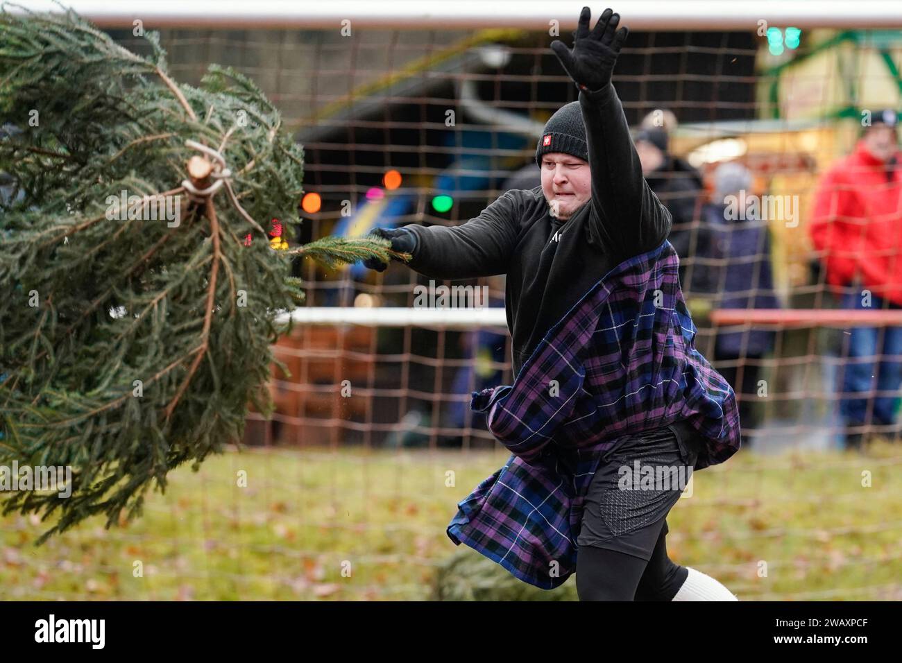 Weidenthal, Germany. 07th Jan, 2024. A participant hurls a spruce at ...