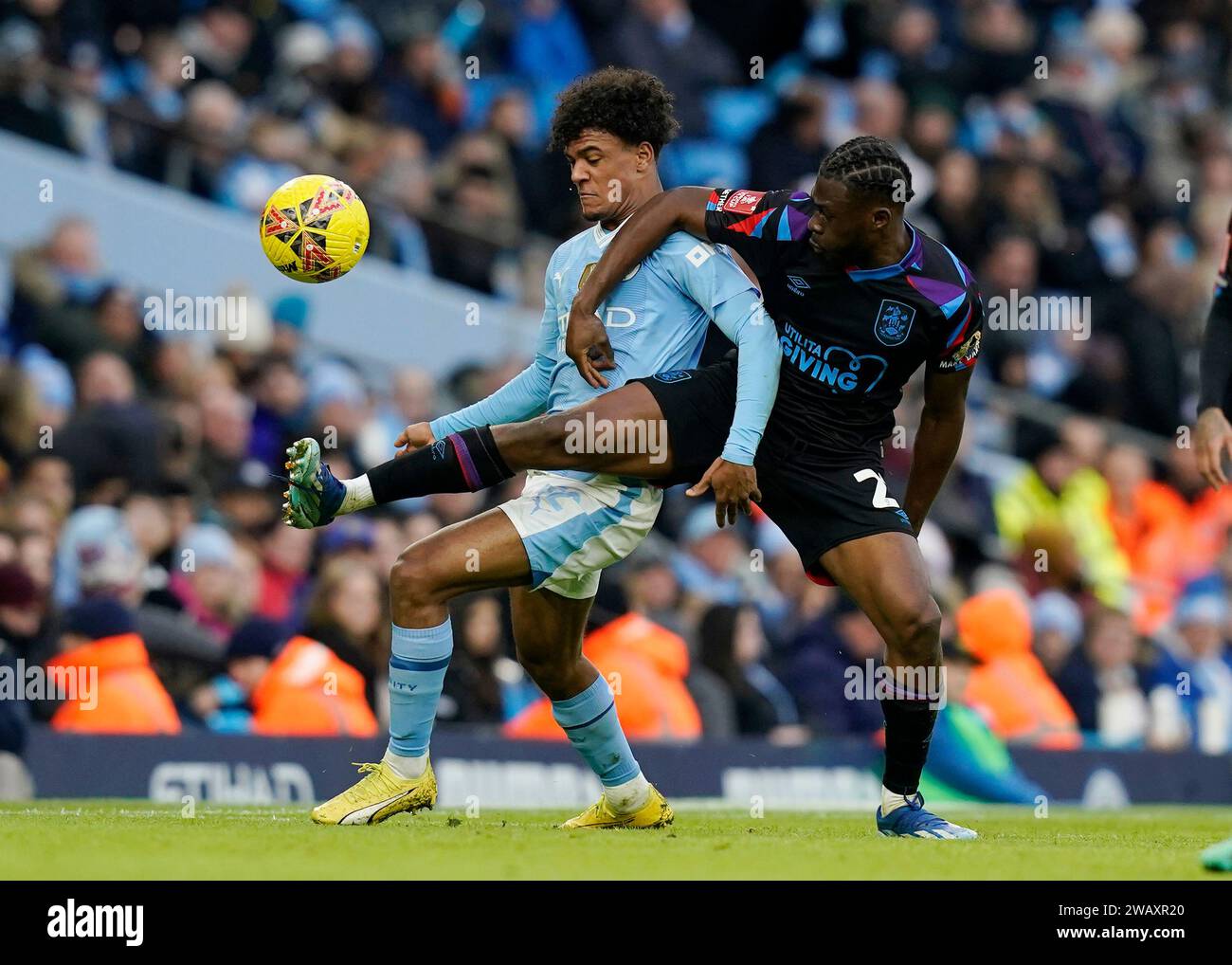 Manchester, UK. 7th Jan, 2024. Oscar Bobb of Manchester City tussles ...