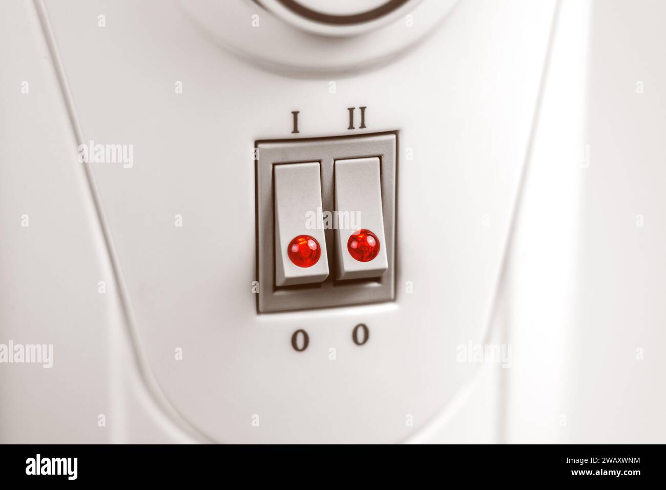 Turned on hot heating radiator with two switches and indicator red ...