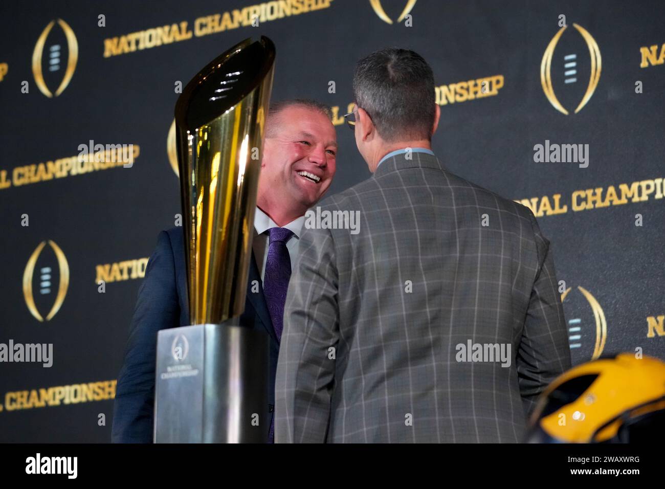 Washington head coach Kalen DeBoer, left, and Michigan head coach Jim ...