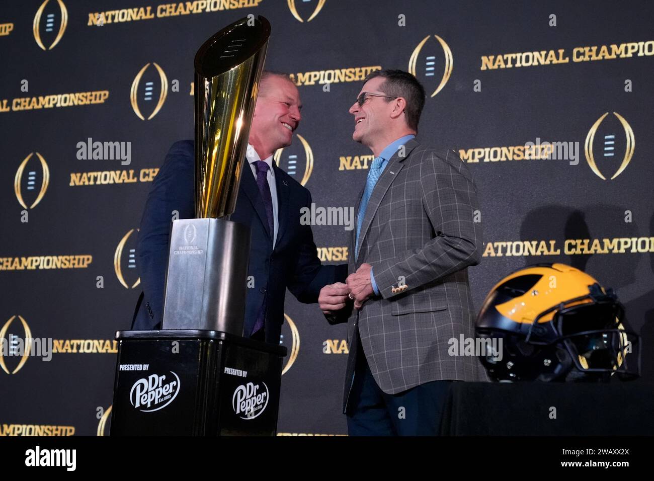 Washington head coach Kalen DeBoer, left, and Michigan head coach Jim ...
