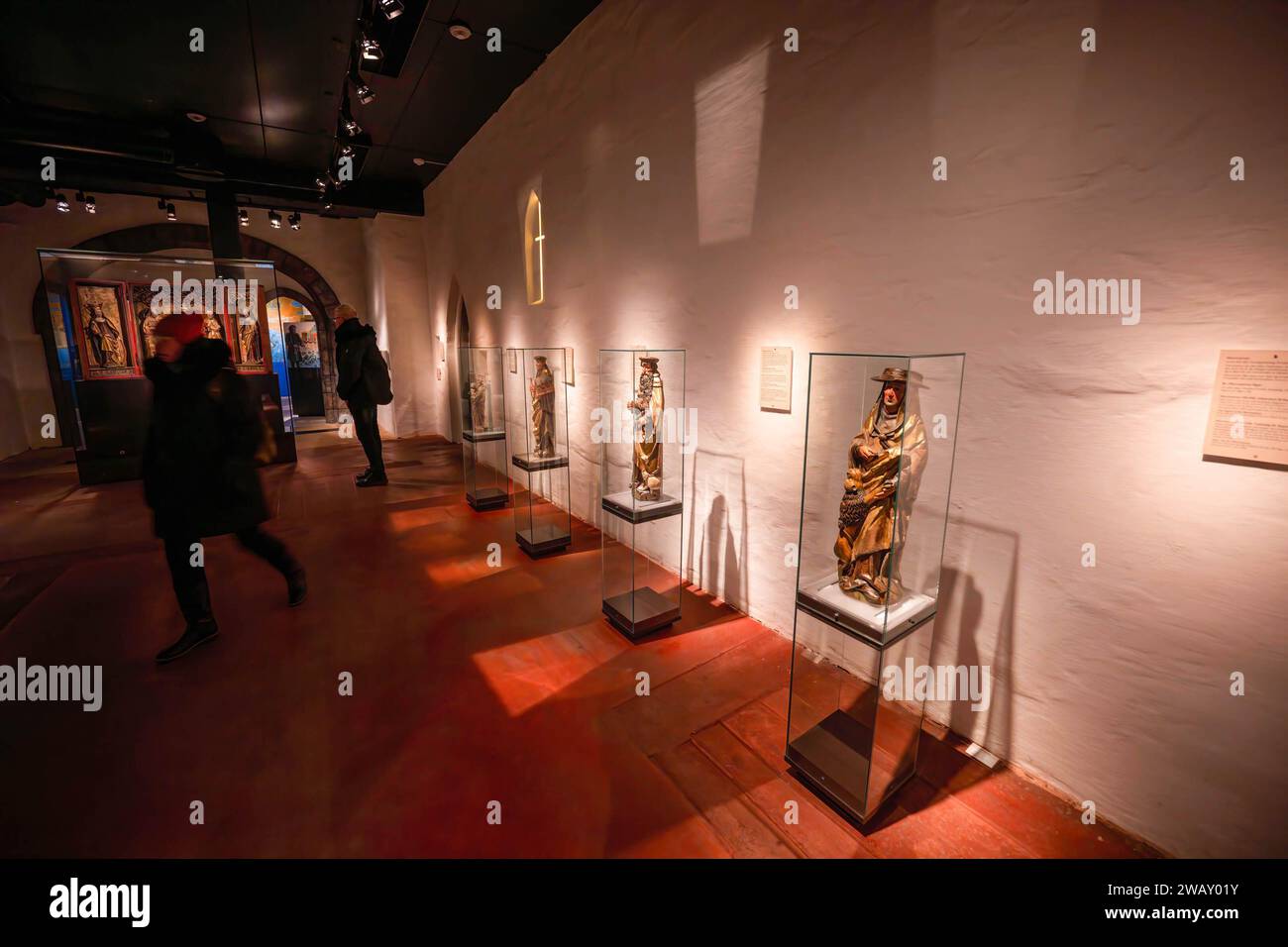 People seen through one of the rooms displaying artifacts and ...