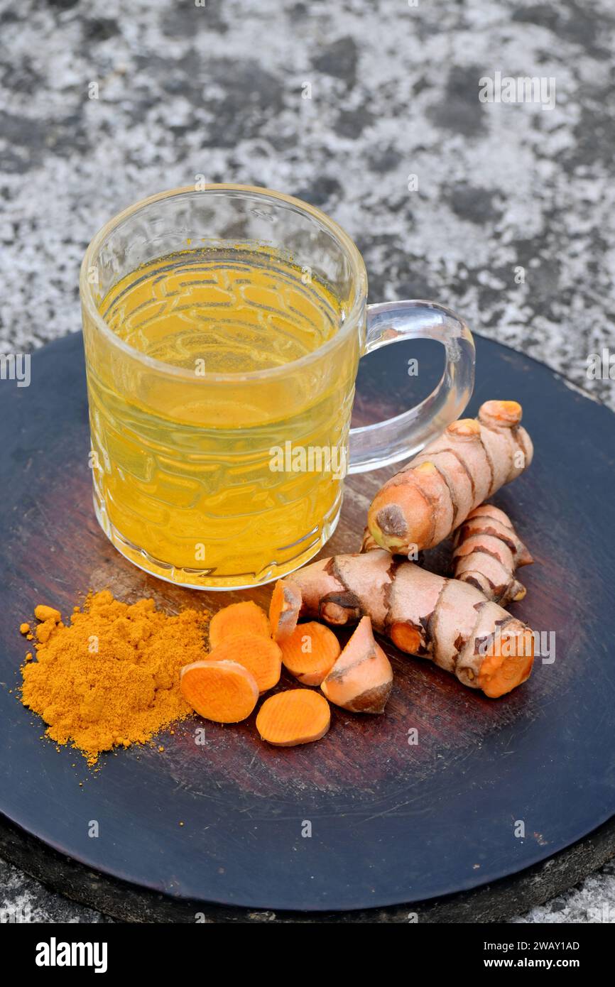closeup the bunch sliced orange turmeric with juice and powder on the ...