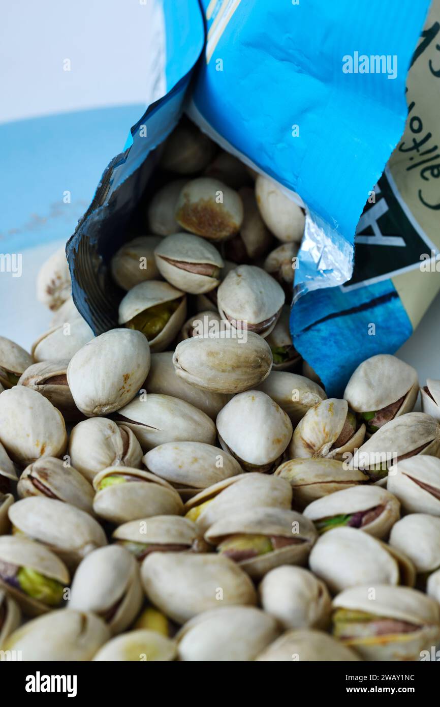 Opened packet of pistachio nuts Stock Photo - Alamy