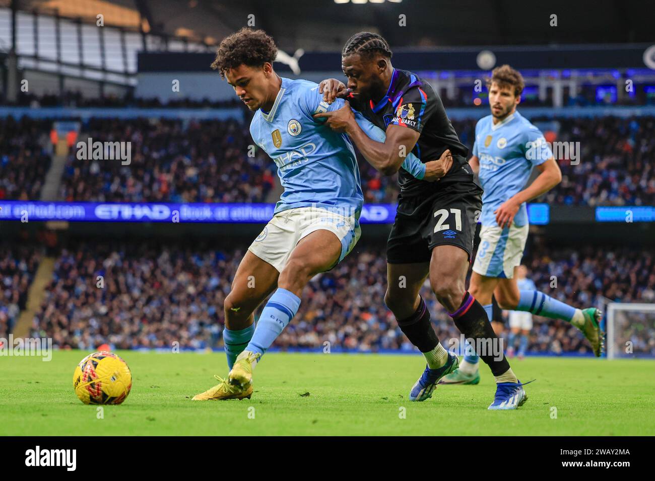 Manchester, UK. 07th Jan, 2024. Oscar Bobb of Manchester City holds off ...