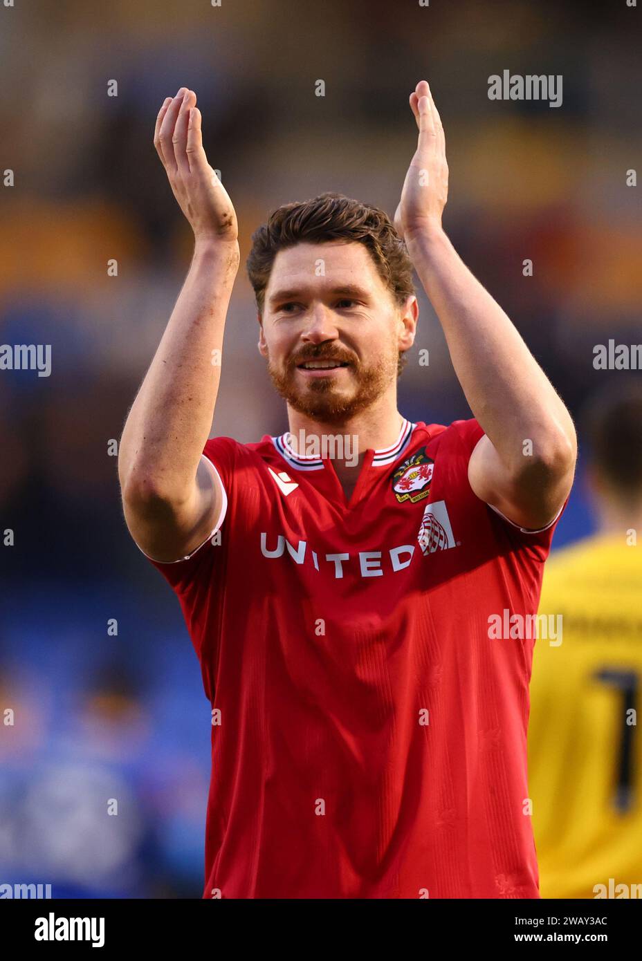 Shrewsbury, UK. 7th Jan, 2024. George Evans of Wrexham applauds the ...