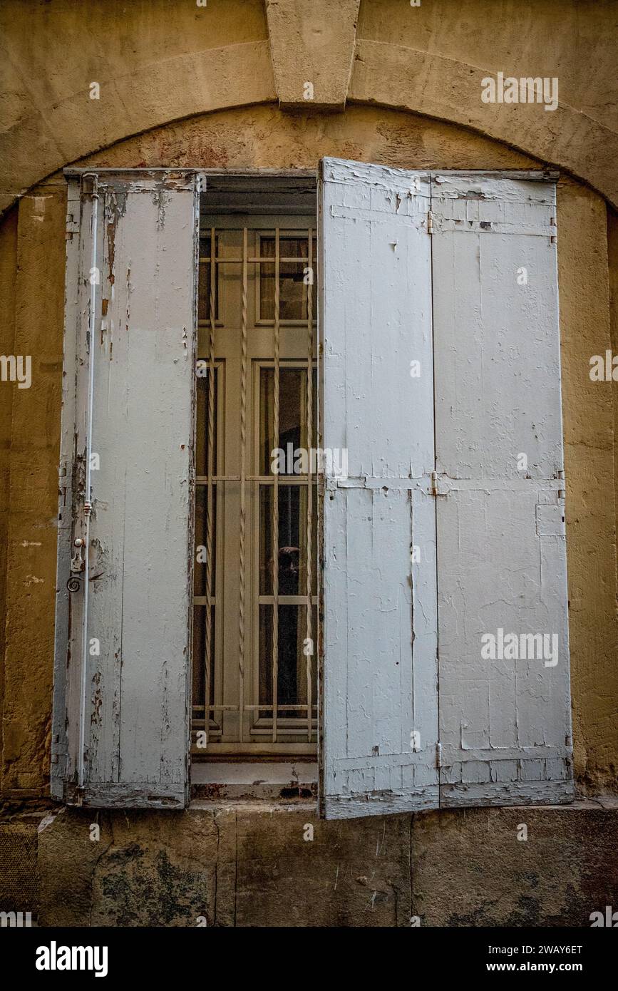 Half open wooden window shutters on an old house, Montpellier, France ...