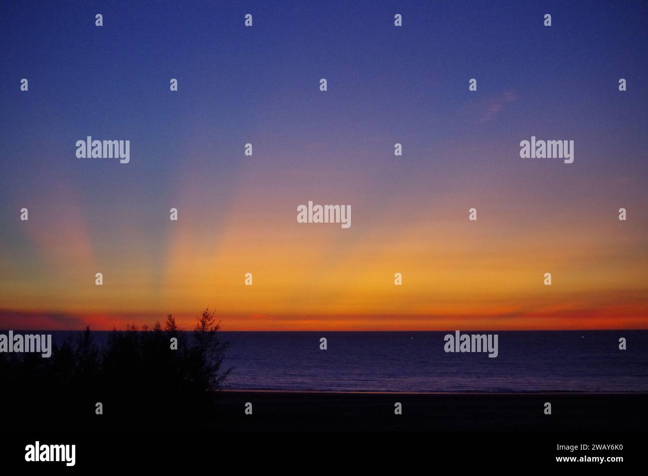 Crepuscular rays at sunset at Pantai Dalit beach, Sabah, Borneo Stock ...