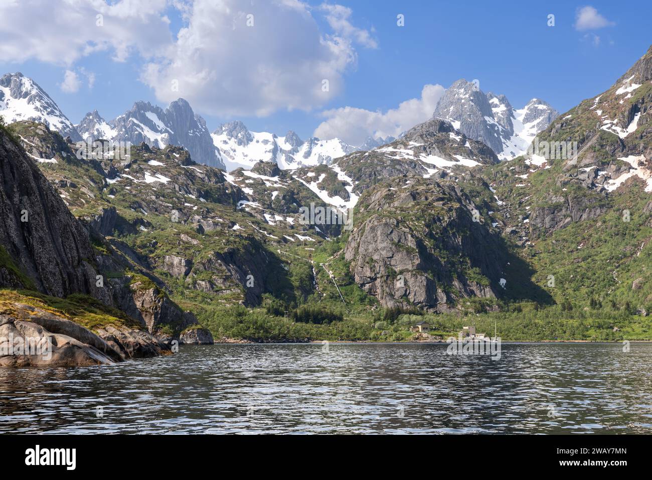 A view of Trollfjorden, Lofoten, where rugged mountains adorned with ...