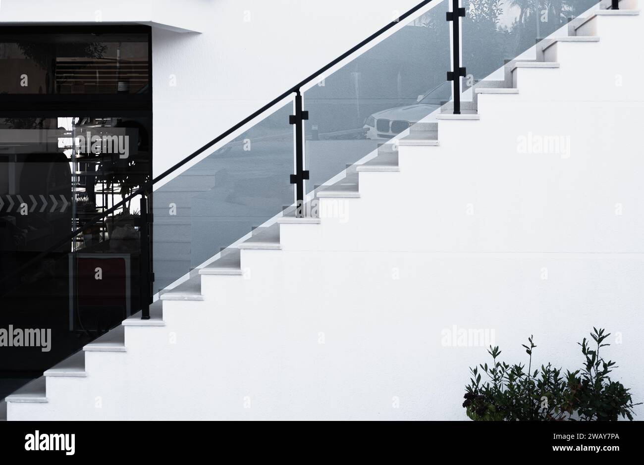 White steps with glass railing. Stone staircase in residential house ...