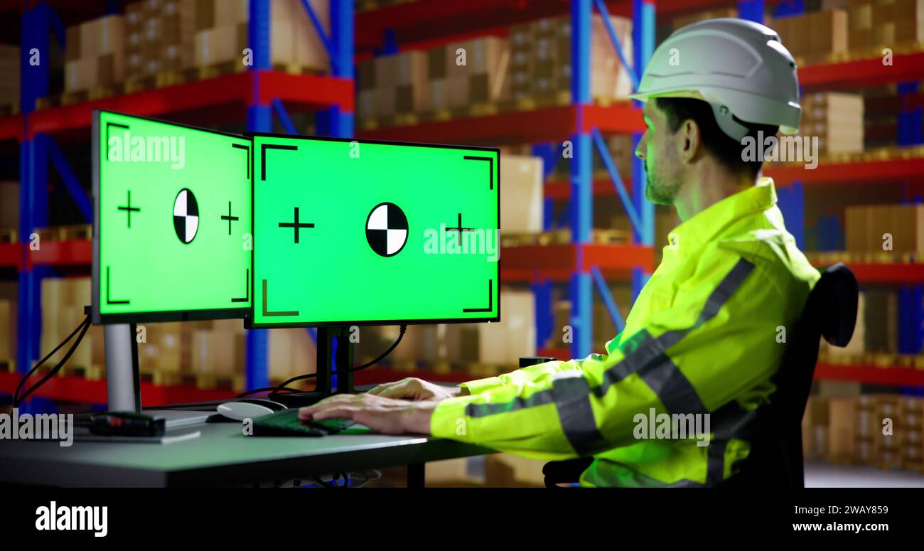 Engineer Using PC Monitor With Green Screen Stock Photo - Alamy