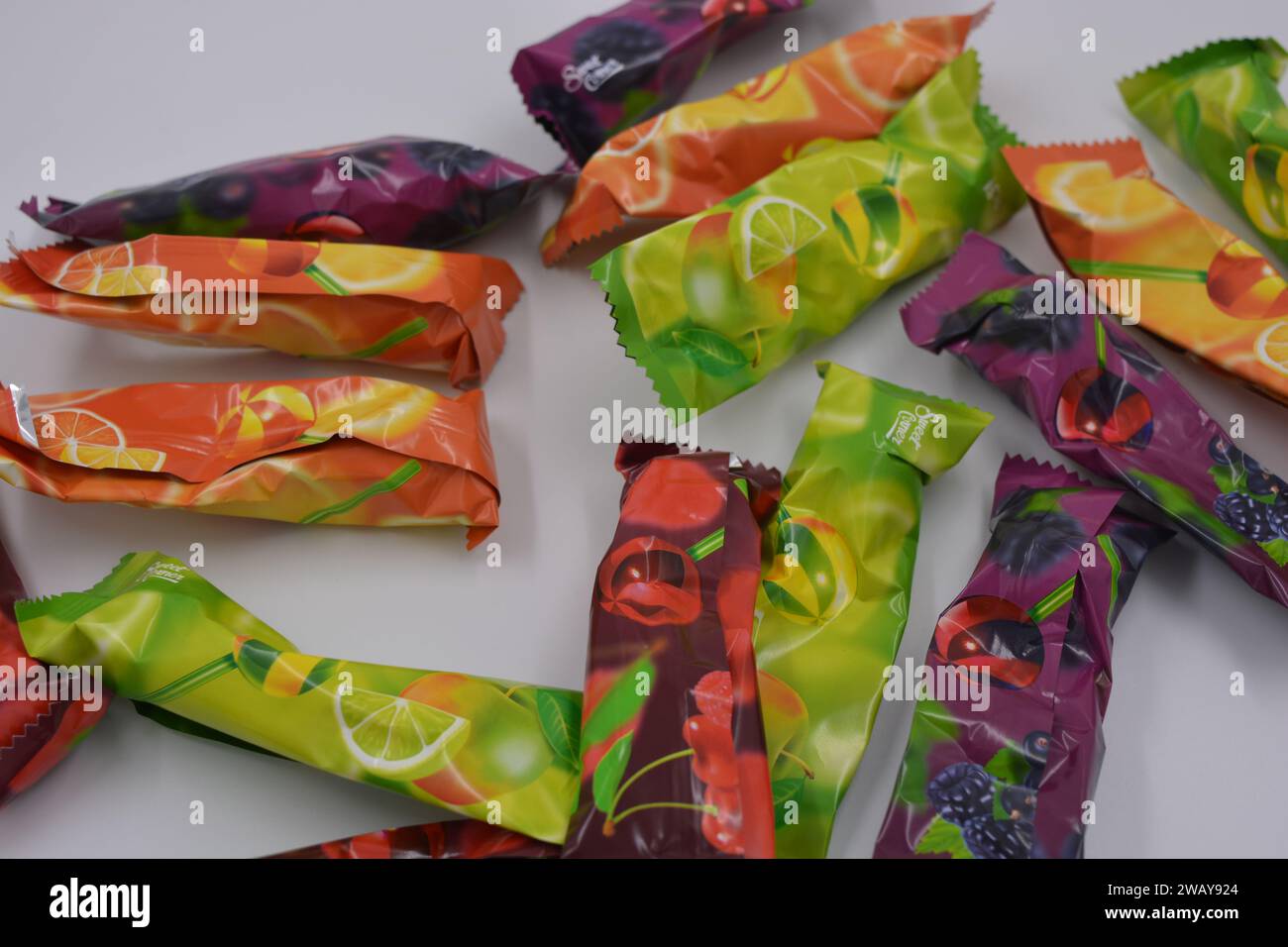 Bright, colorful factory candies on a stick packed in colored and ...