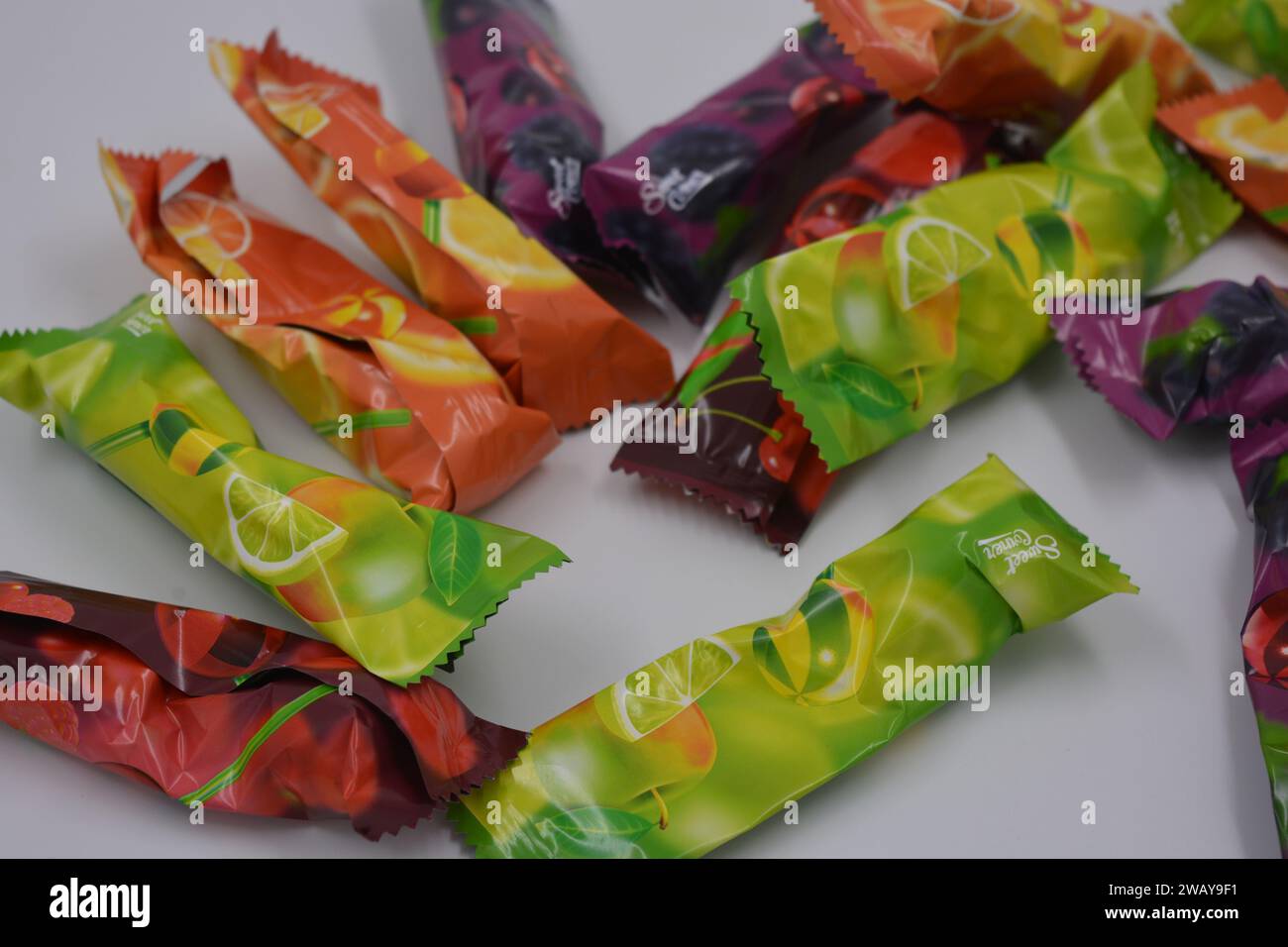 Bright, colorful factory candies on a stick packed in colored and ...