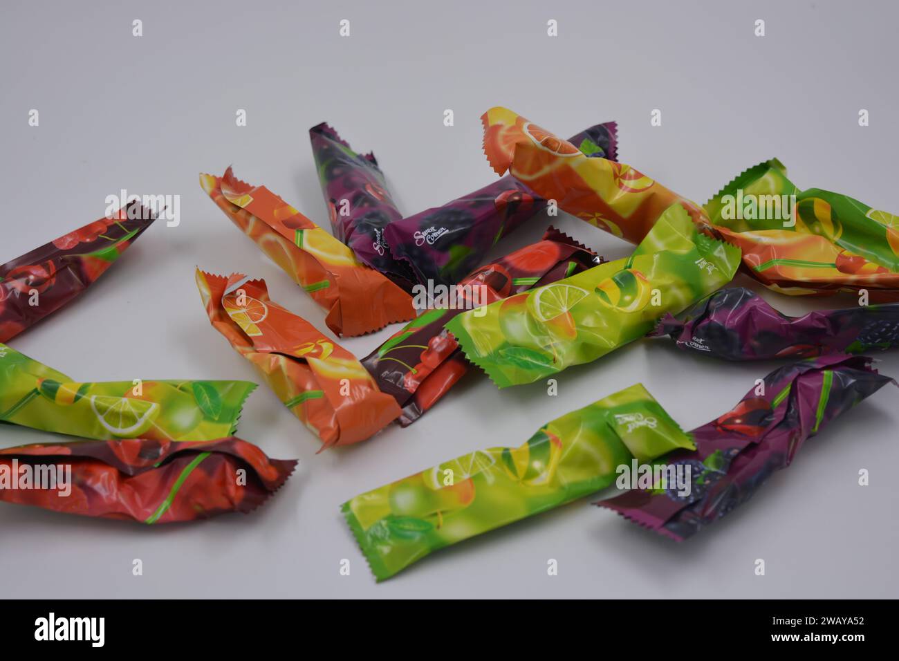 Bright, colorful factory candies on a stick packed in colored and ...