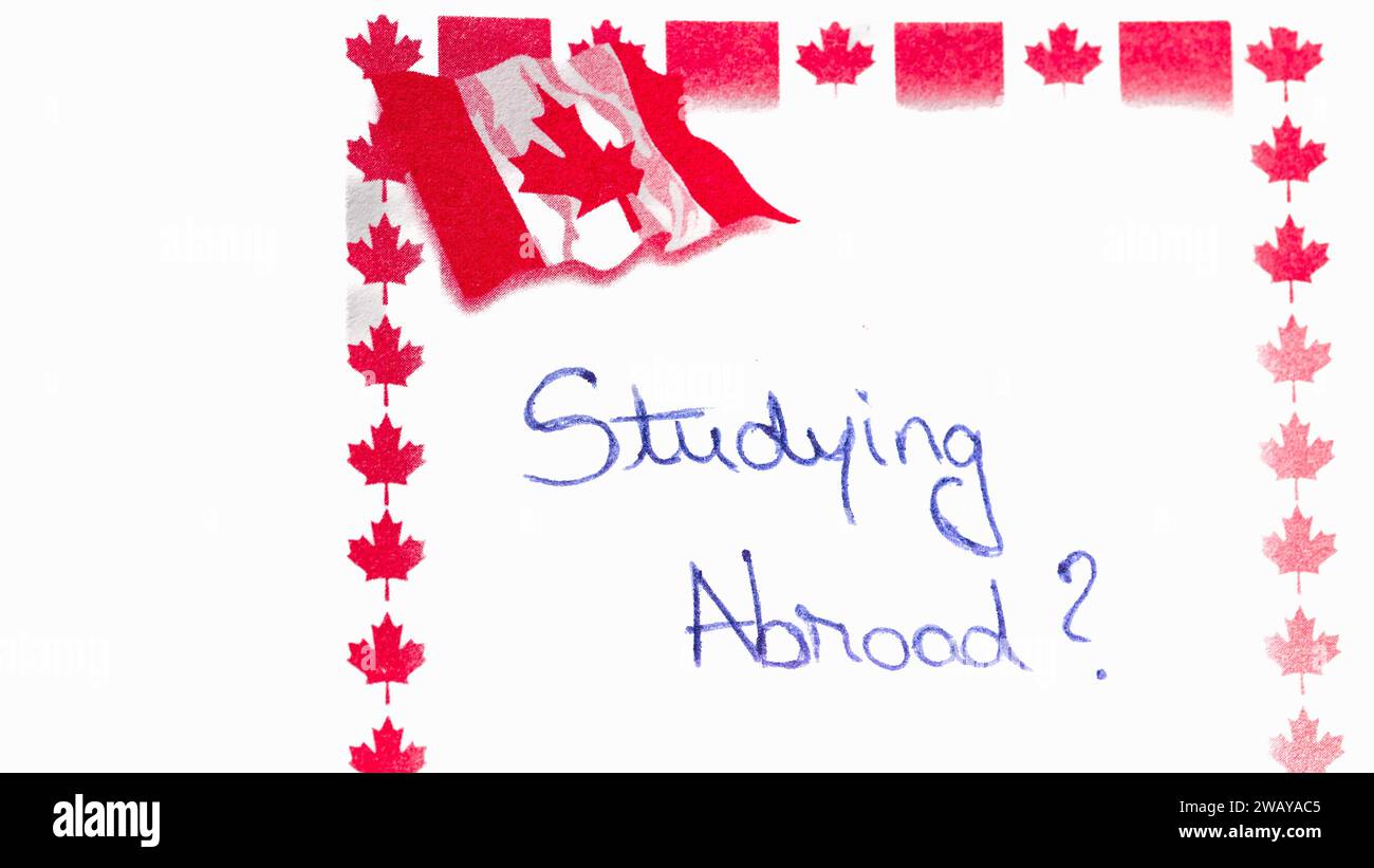 Studying abroad handwriting on paper with Canada flag. Writing text on ...