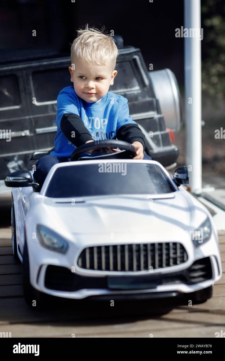 Child driving in a toy car hi-res stock photography and images - Alamy
