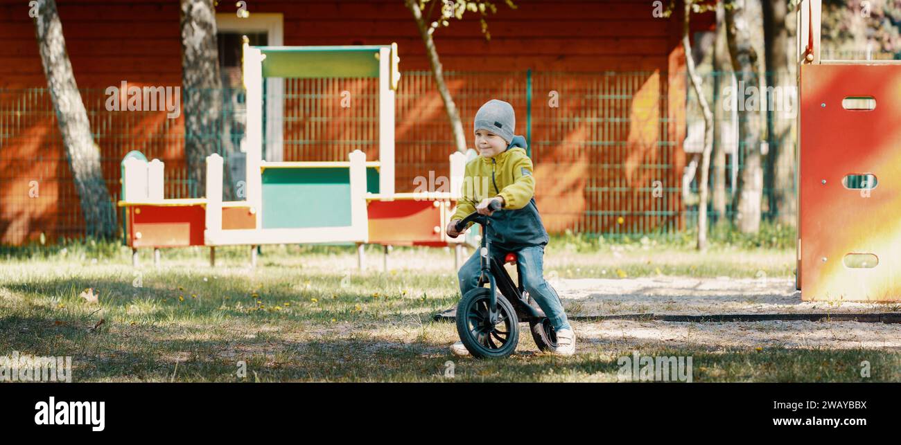 Happy child boy rides a racetrack in Park in the spring Stock Photo - Alamy