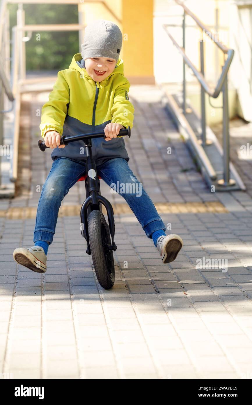 Little boy on a bicycle. Caught in motion, on a driveway. Preschool ...