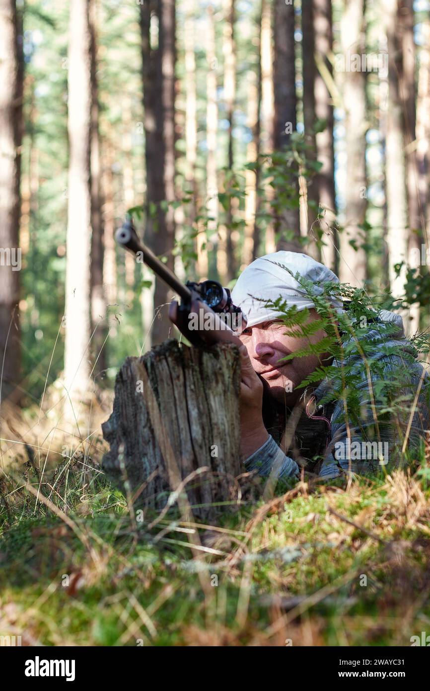 Shooting in the forest from an air rifle with an optical sight. Sunny ...