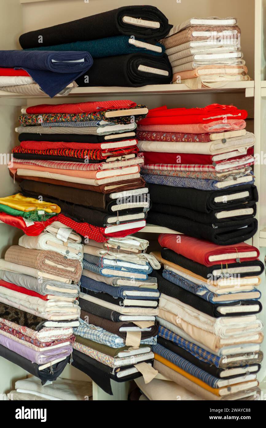 A shelf full of colorful fabrics, an antique shop. Vertical photo Stock ...