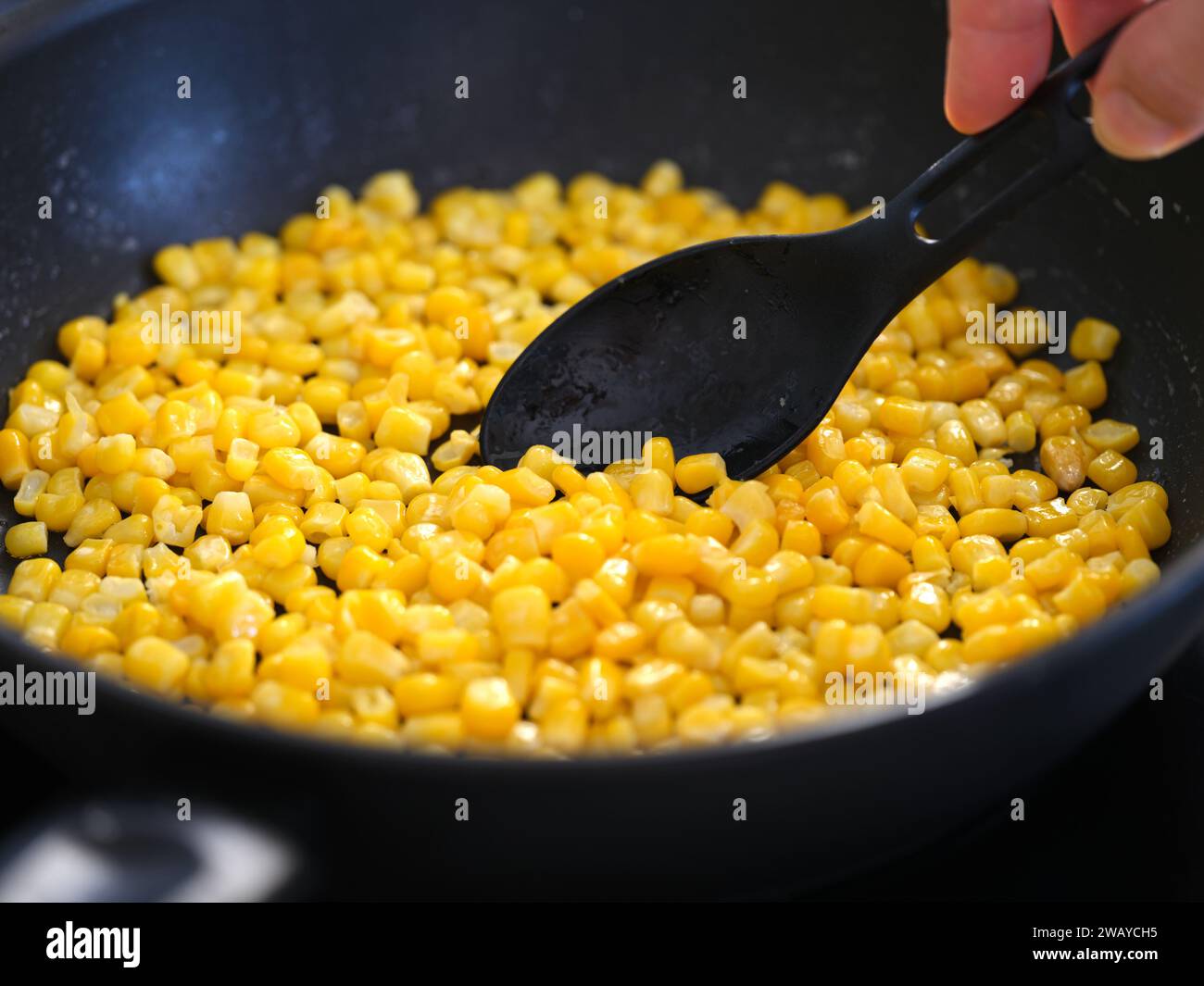 Cooking woman in yellow hi-res stock photography and images - Alamy