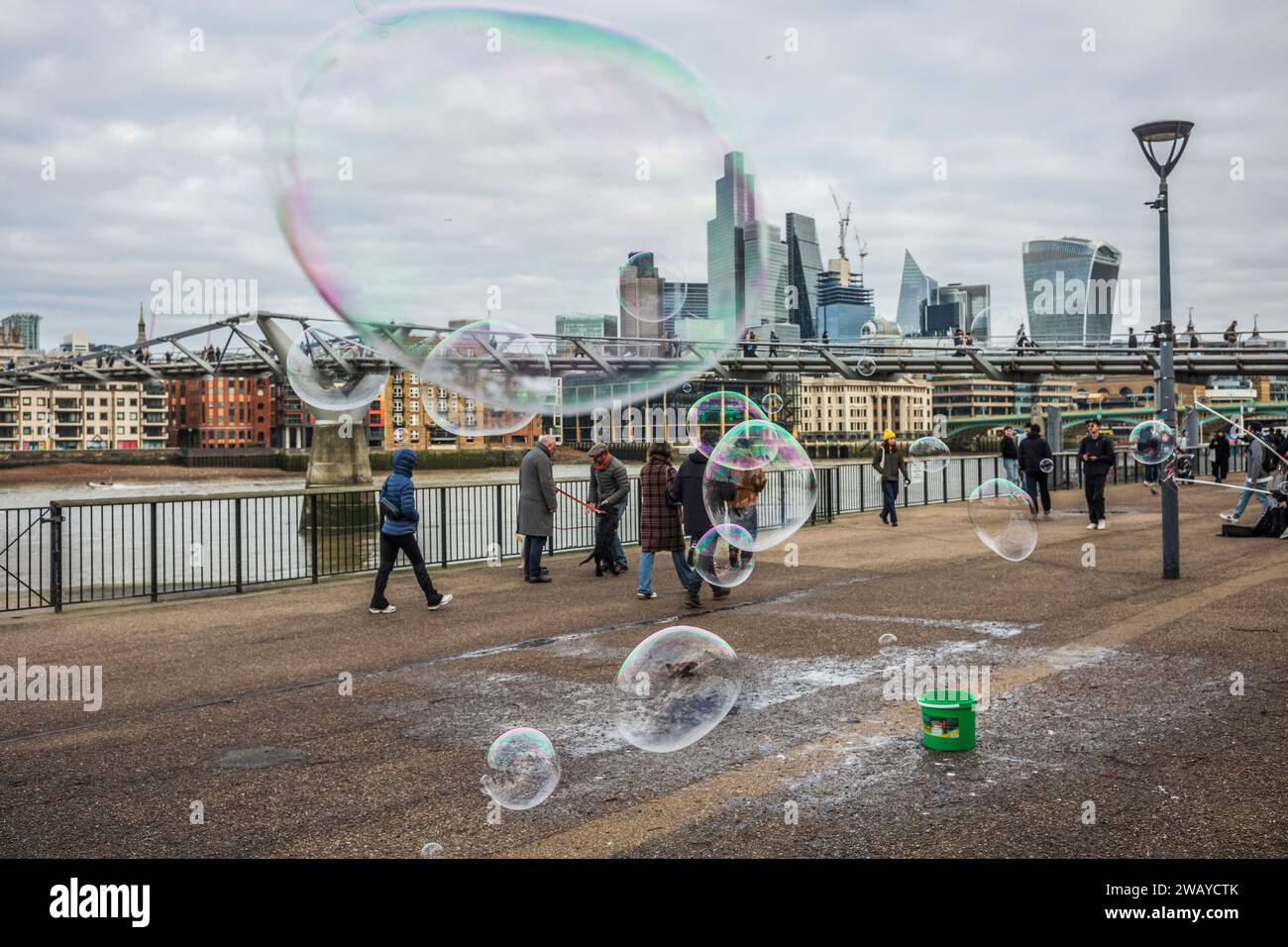 A cloud of liquid bubbles blow across the City of London skyline during ...