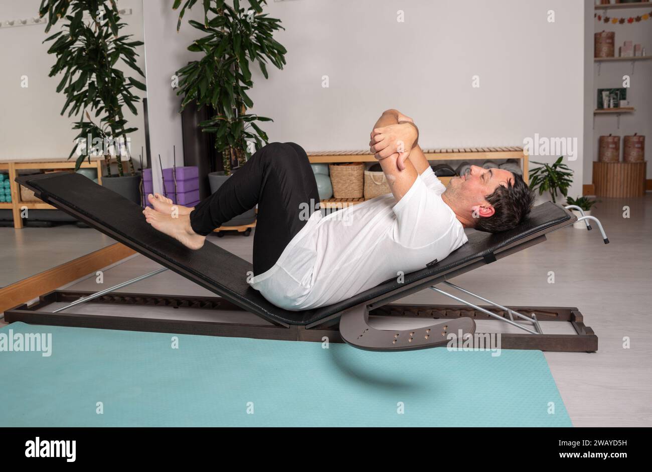 Relaxed man learning yoga poses with teacher Stock Photo - Alamy