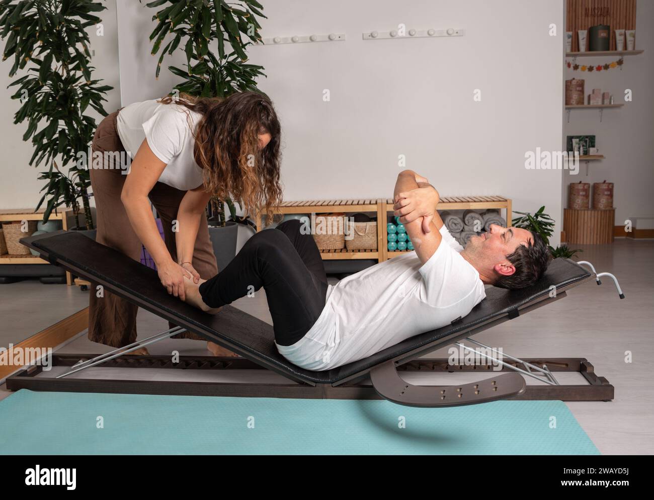 Relaxed man learning yoga poses with teacher Stock Photo - Alamy