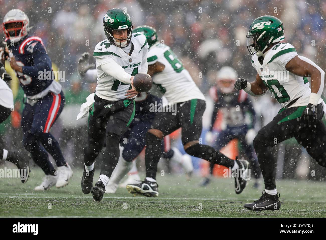 New York Jets quarterback Trevor Siemian, left, hands off to running ...