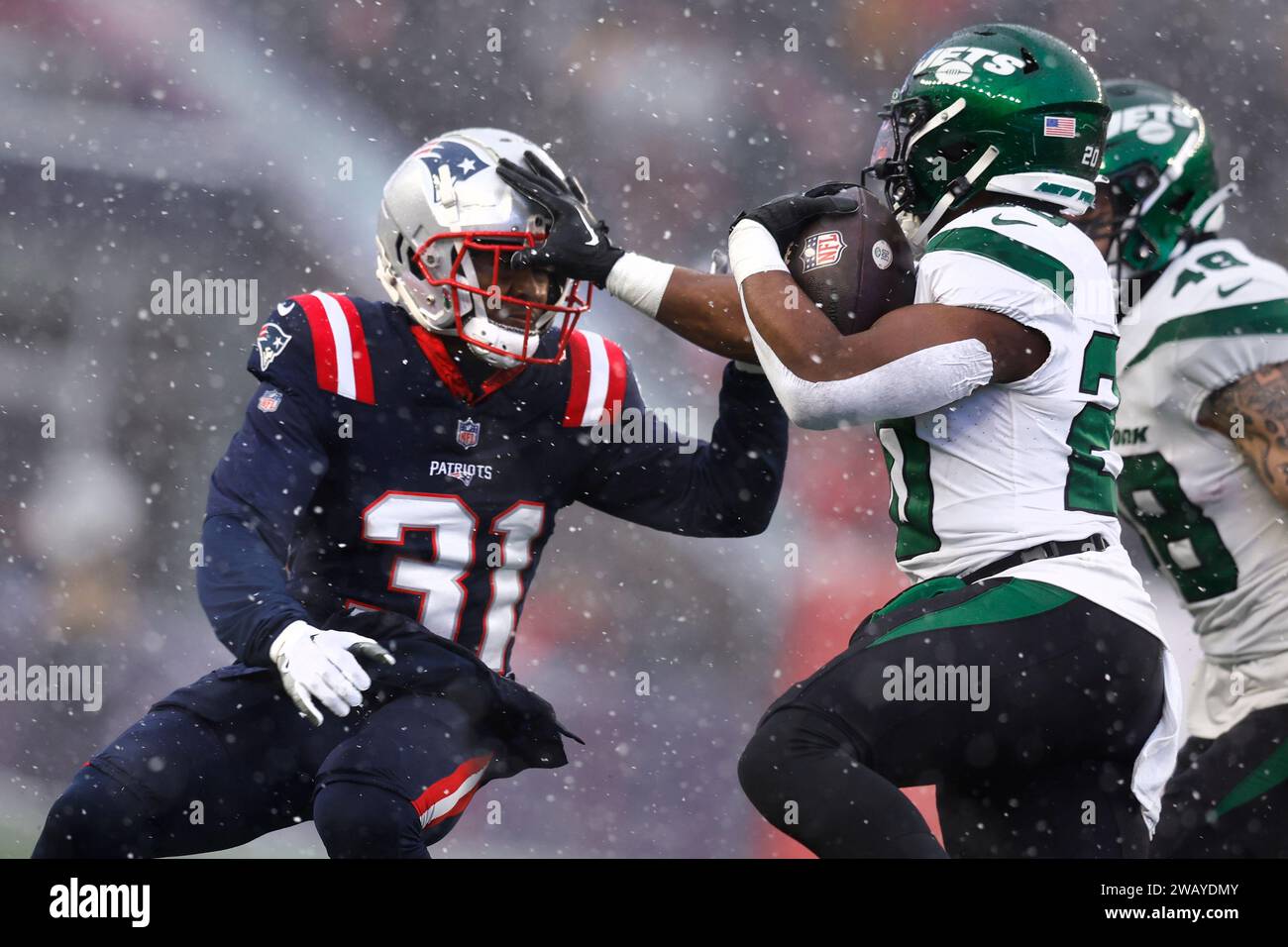 New York Jets running back Breece Hall, right, pushes New England ...