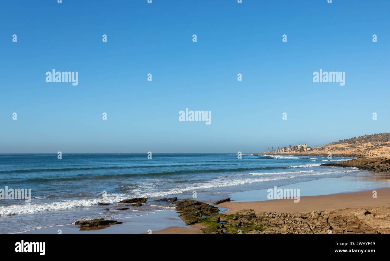 A wide-angle view of a bay in Taghazout, near Agadir, with sandy and ...