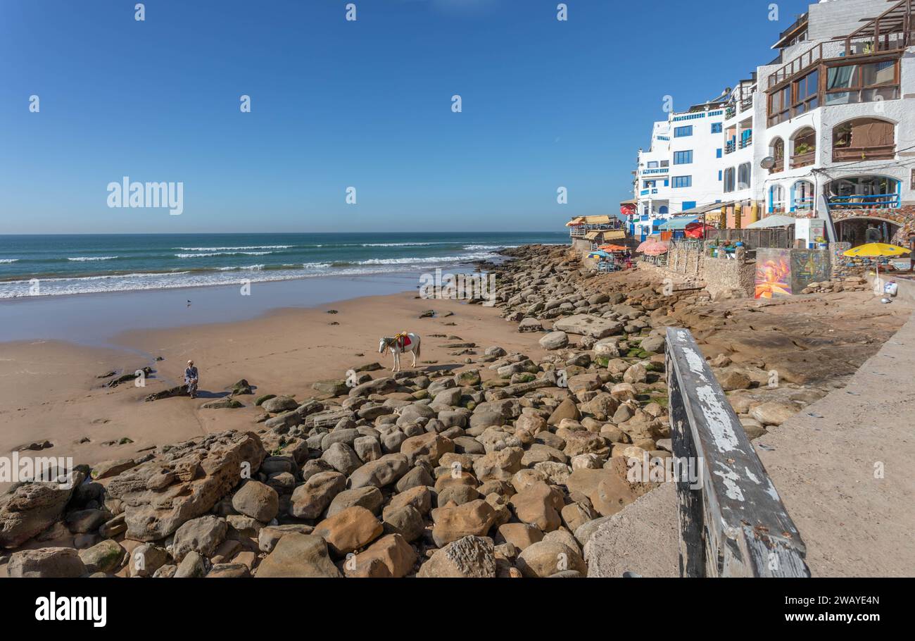 Beachfront buildings on coastal path, with Atlantic Ocean and sandy ...