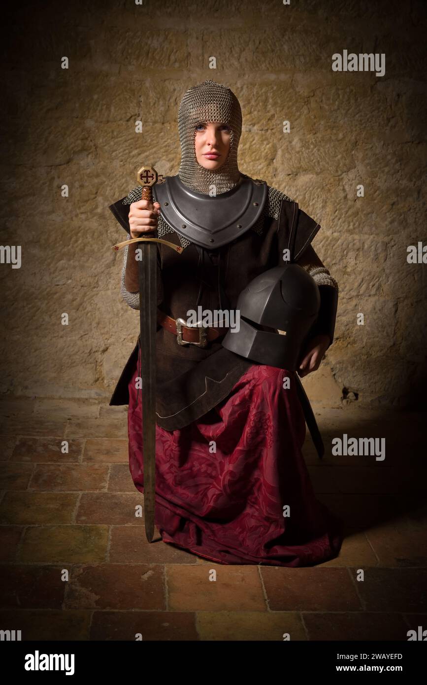 Reenactment scene of a female medieval knight in armor depicting the ...