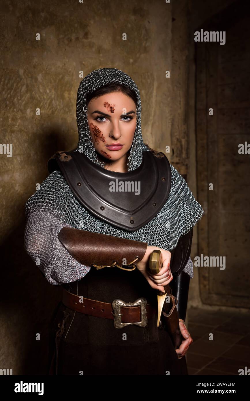 Young woman reenacting a female medieval knight wearing a leather tunic ...