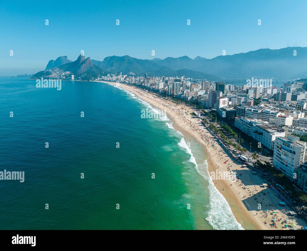 Aerial view of Ipanema beach and Leblon. People sunbathing and playing on the beach, sea sports ...