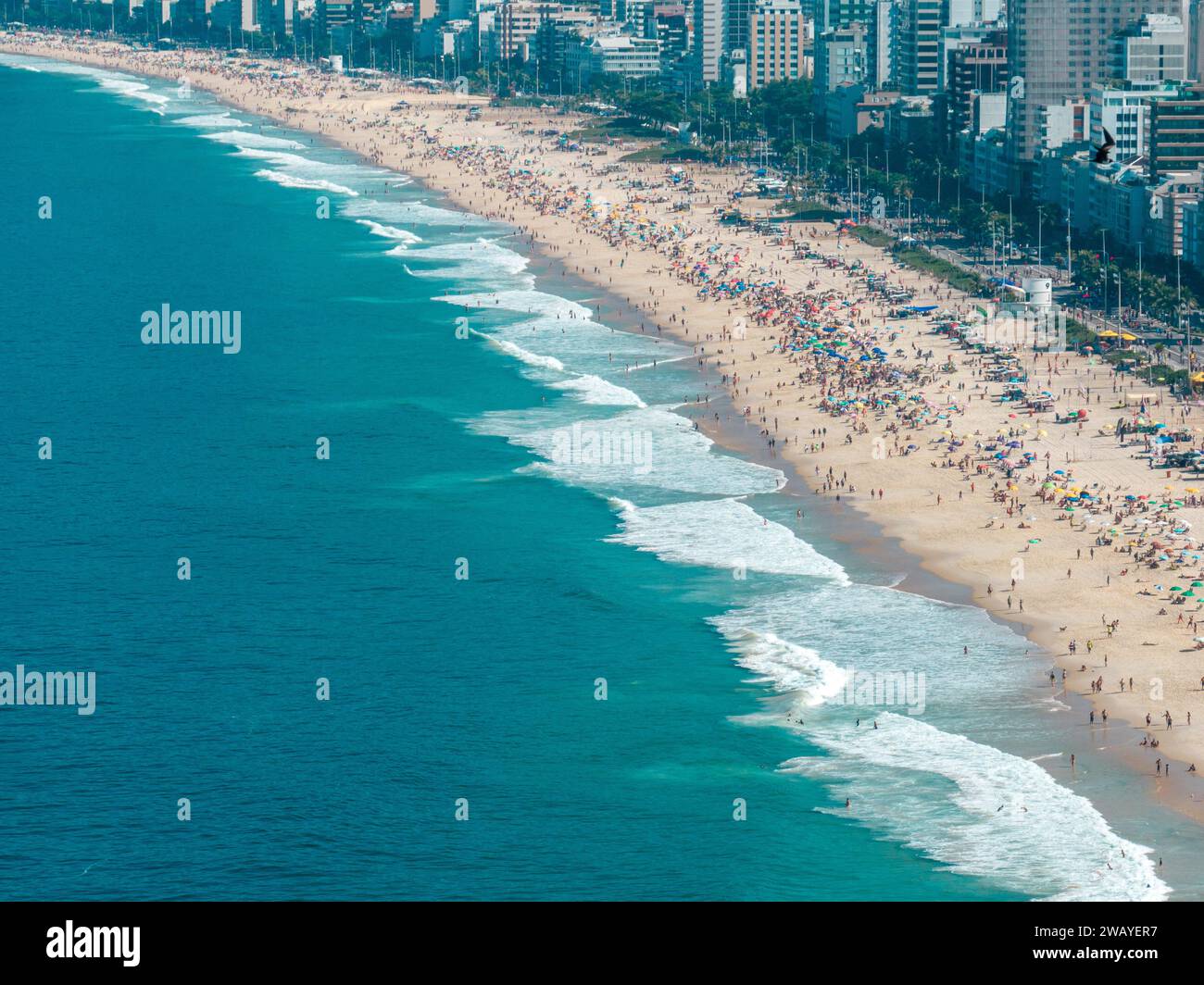 Aerial view of Ipanema beach and Leblon. People sunbathing and playing on the beach, sea sports ...