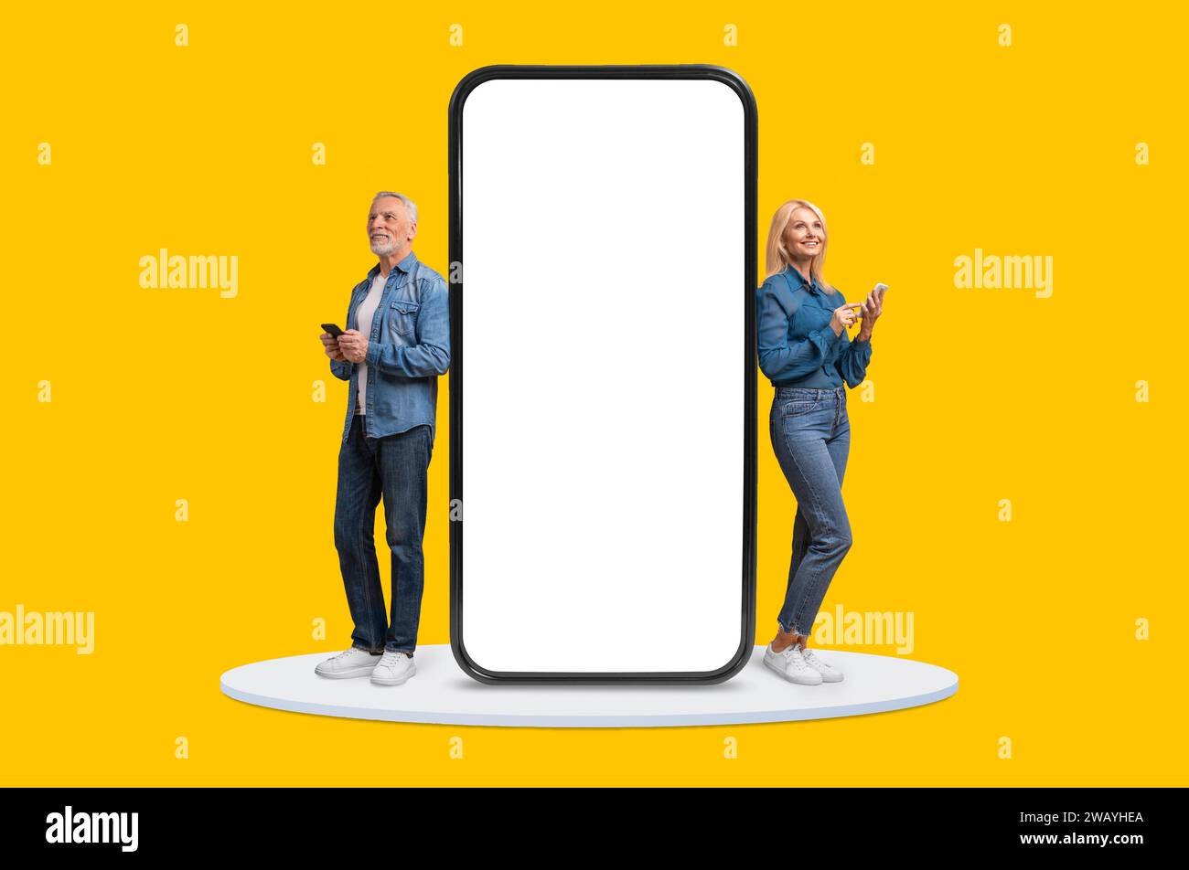 Seniors with mobiles by huge screen on yellow background Stock Photo ...