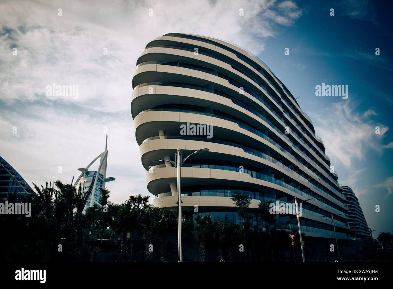 A modern architectural structure stands beside a paved highway Stock ...