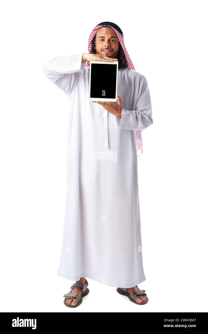 Young Arab man in traditional dress thobe showing digital tablet with ...